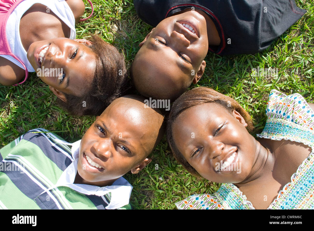 group of african american children lying on grass Stock Photo - Alamy