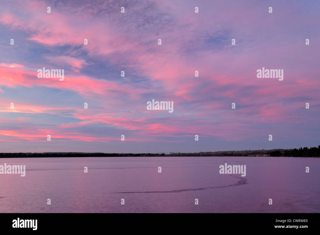 Ice-covered Audy Lake at sunset, Riding Mountain National Park ...