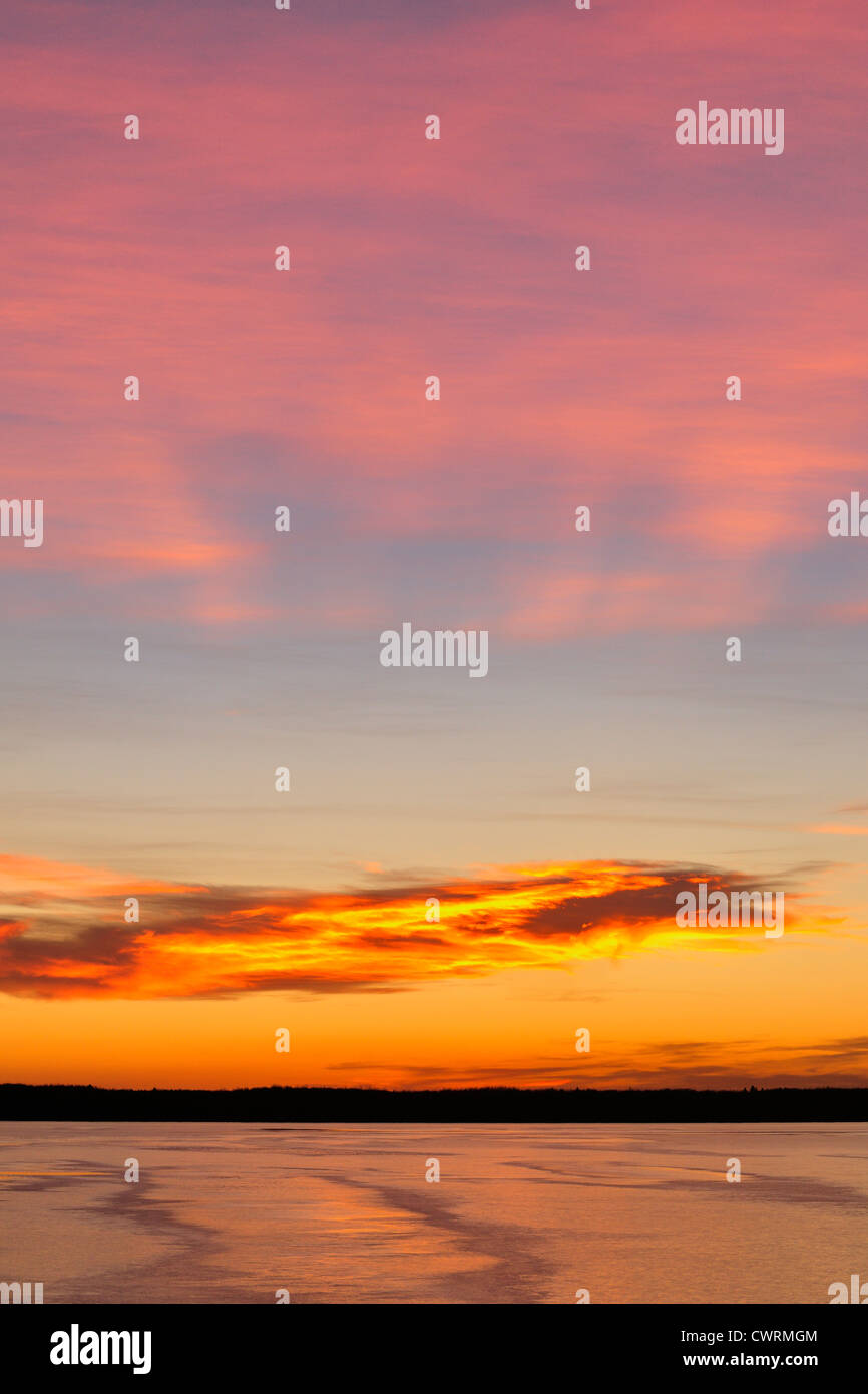Ice-covered Audy Lake at sunset, Riding Mountain National Park ...