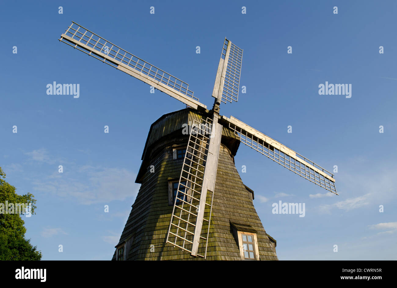 Retro wooden mill with windows and wings against blue sky Stock Photo ...
