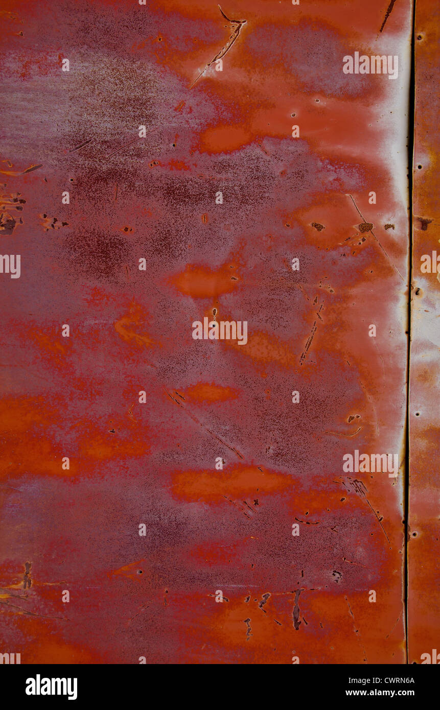 Rusty red painted wall made of tin. Neglected architectural bacground ...