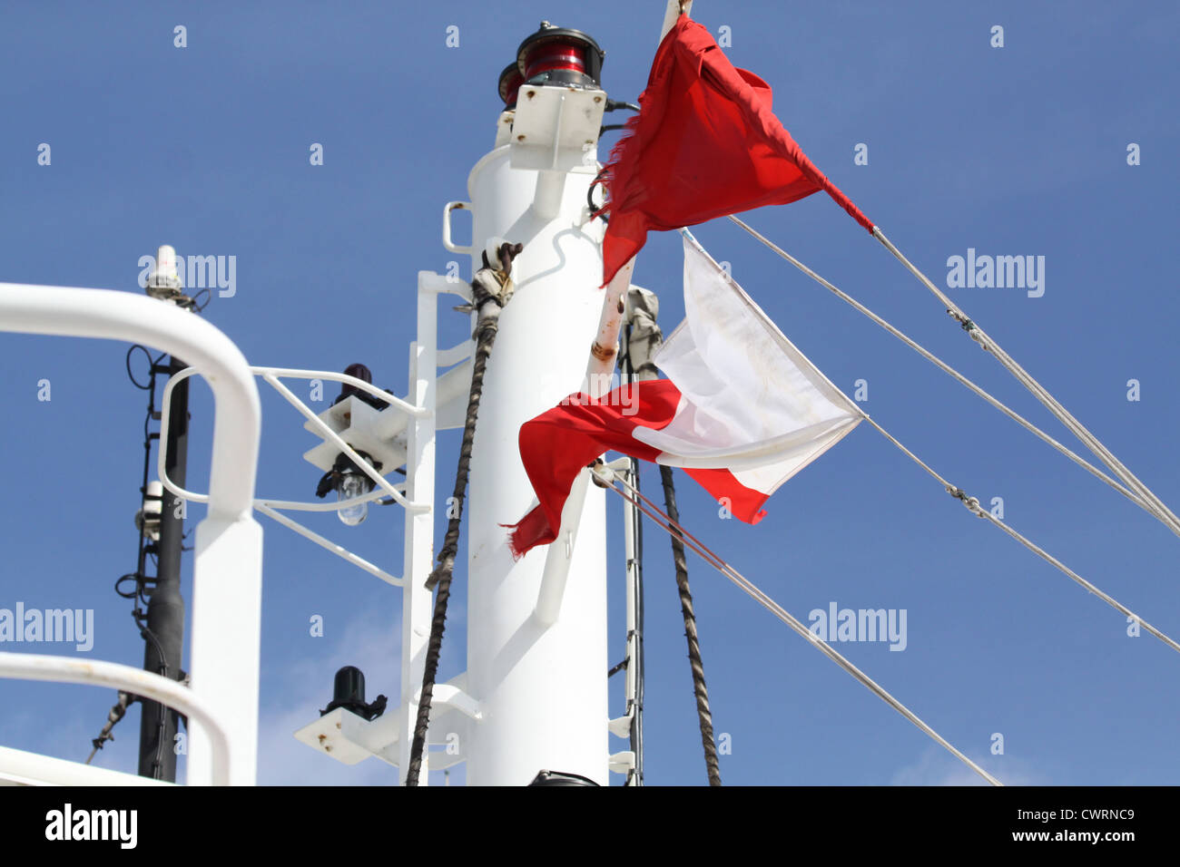 Signal flags flutter at a ship's masthead Stock Photo - Alamy