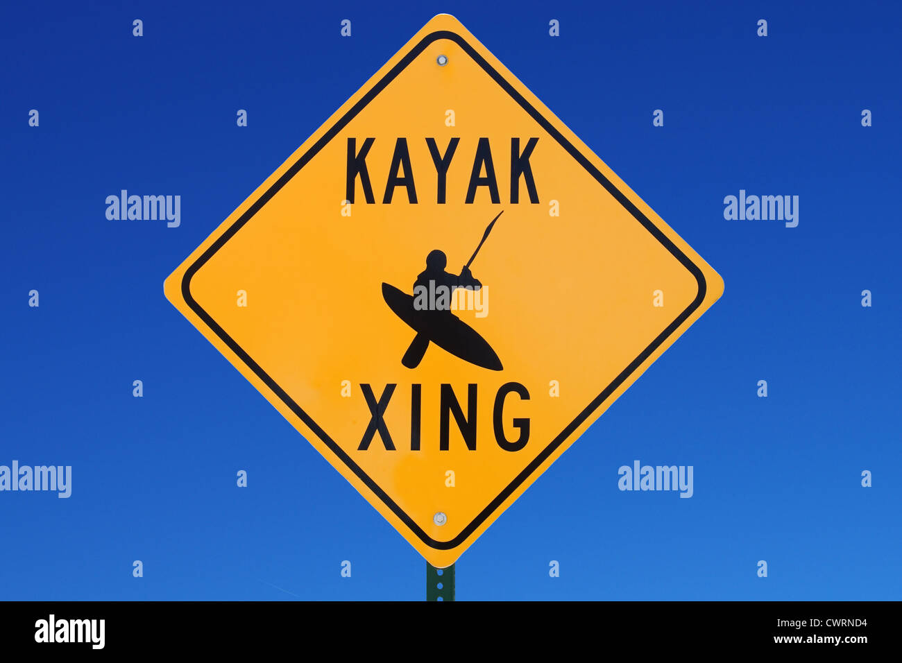 kayak crossing road sign that says kayak xing with blue sky background ...