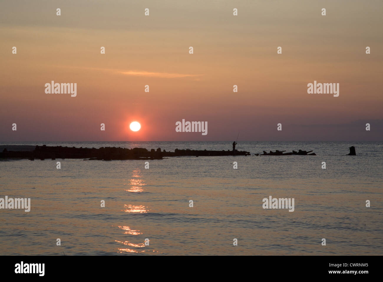 Lone fisherman at sunset on Long Island Sound, Riverhead, NY Stock ...