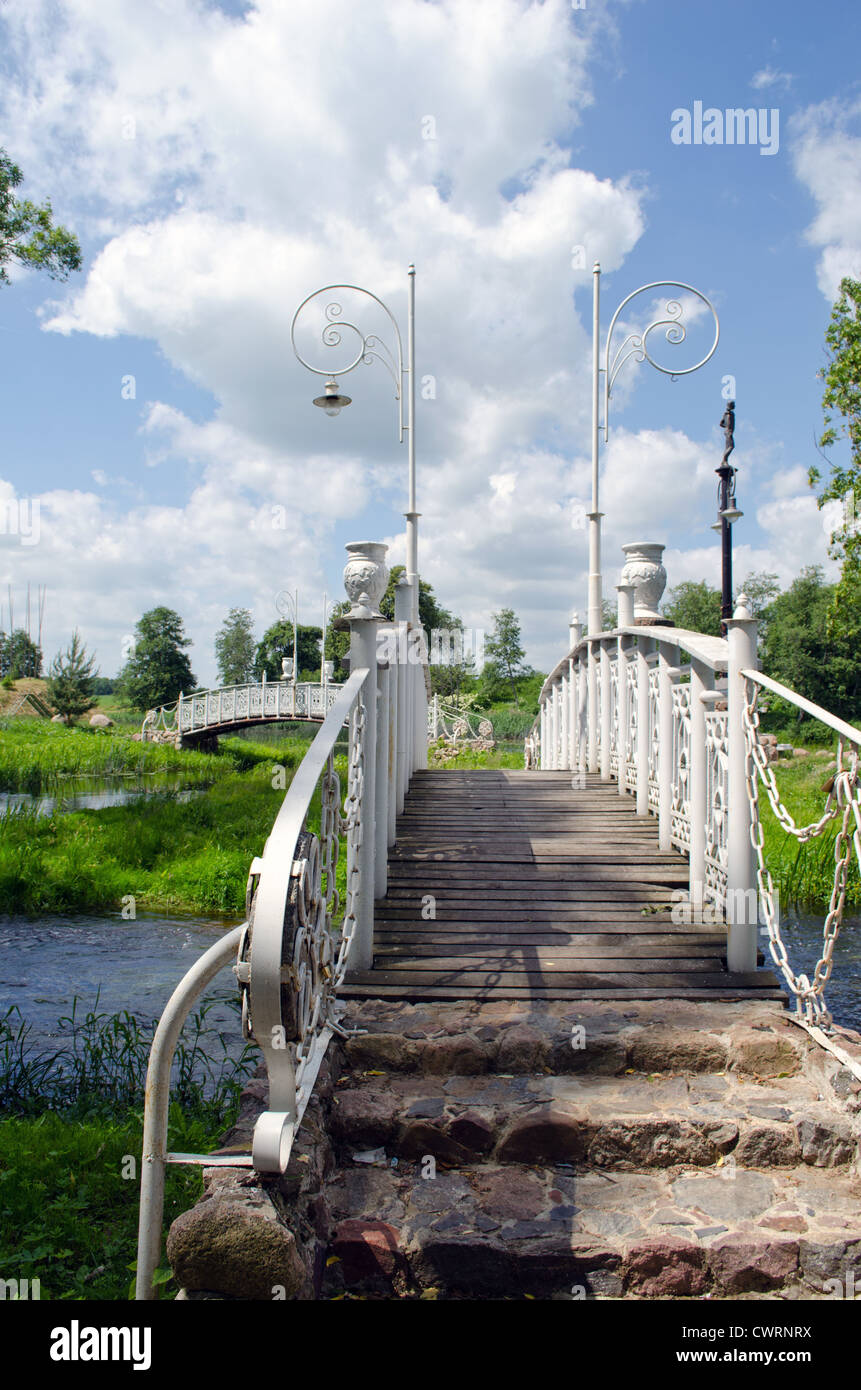 White decorative bridges through park stream and cloudy blue sky Stock ...
