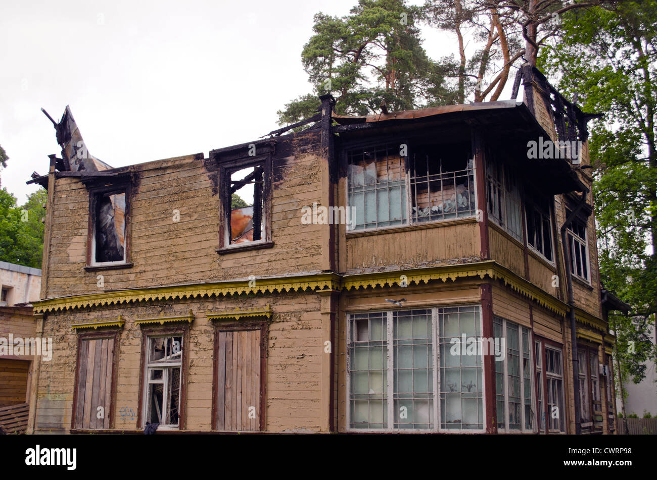 Abandoned old wooden retro house with burnt roof Stock Photo - Alamy