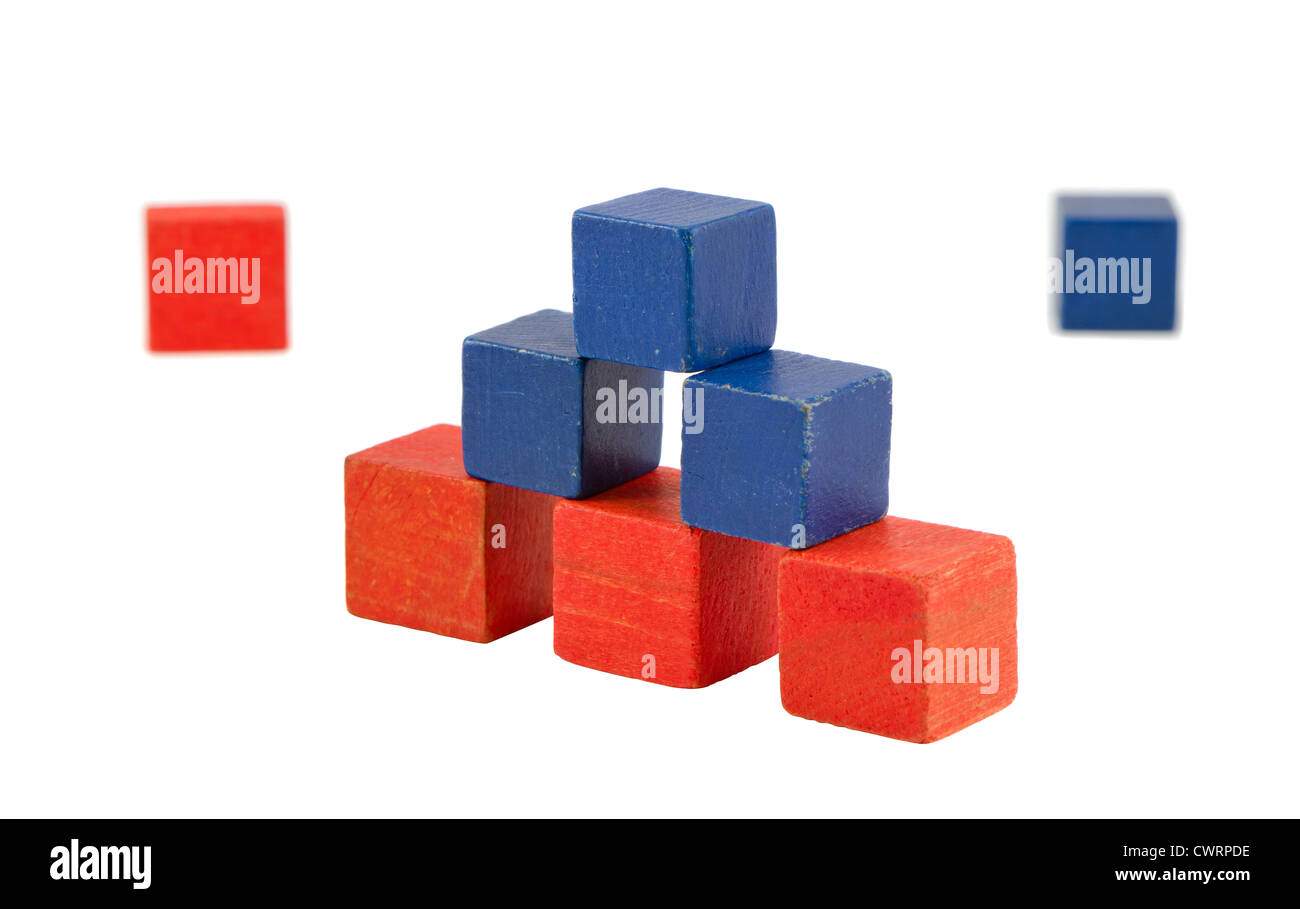 Pyramid made of wooden colorful toy log bricks isolated on white. Pink ...