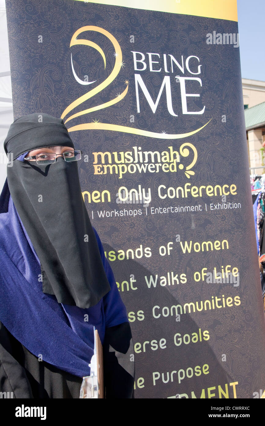 Young Muslim Lady in front of a Muslim Empowered sign ifull body burka ...