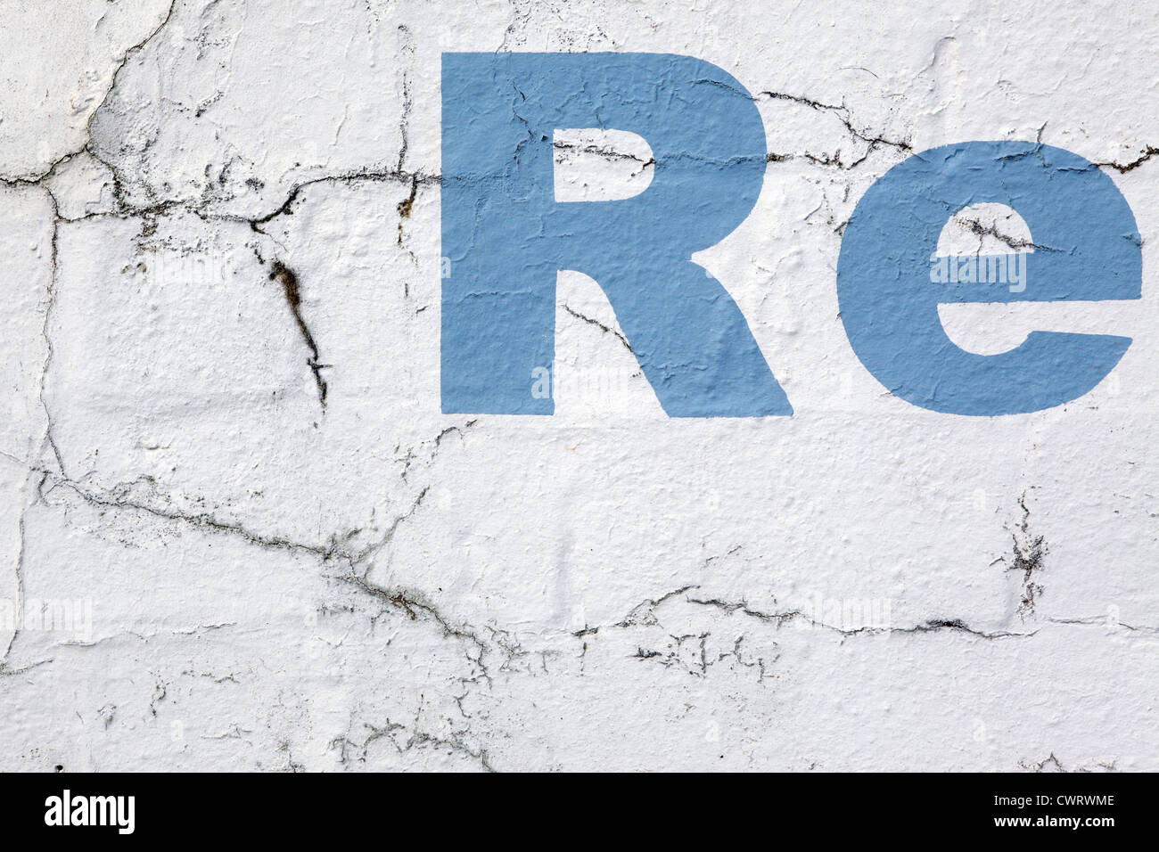 Lettering "Re", stencil style sky blue paint on a white washed wall ...