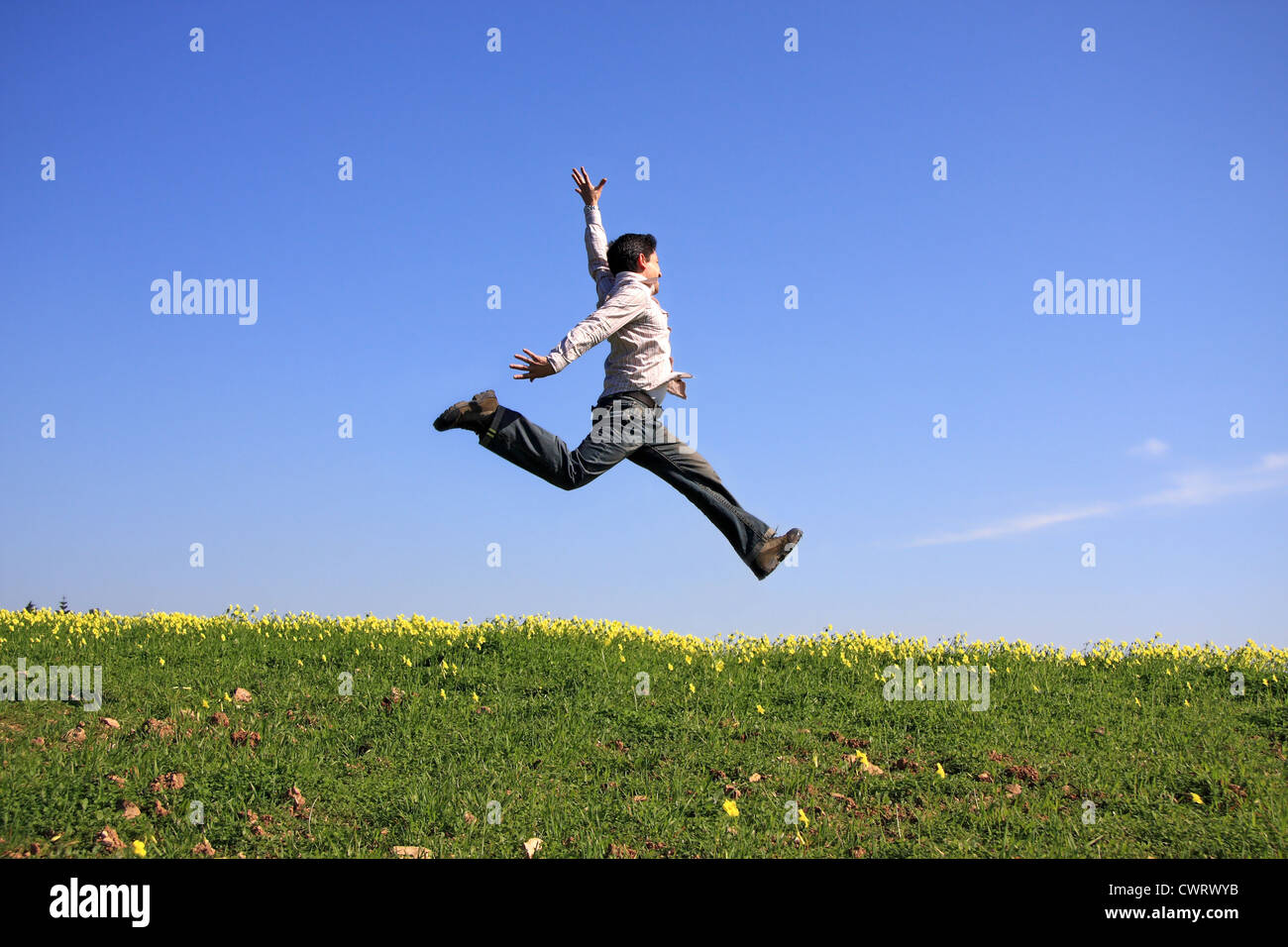 Young man jumping in a beautiful landscape Stock Photo - Alamy