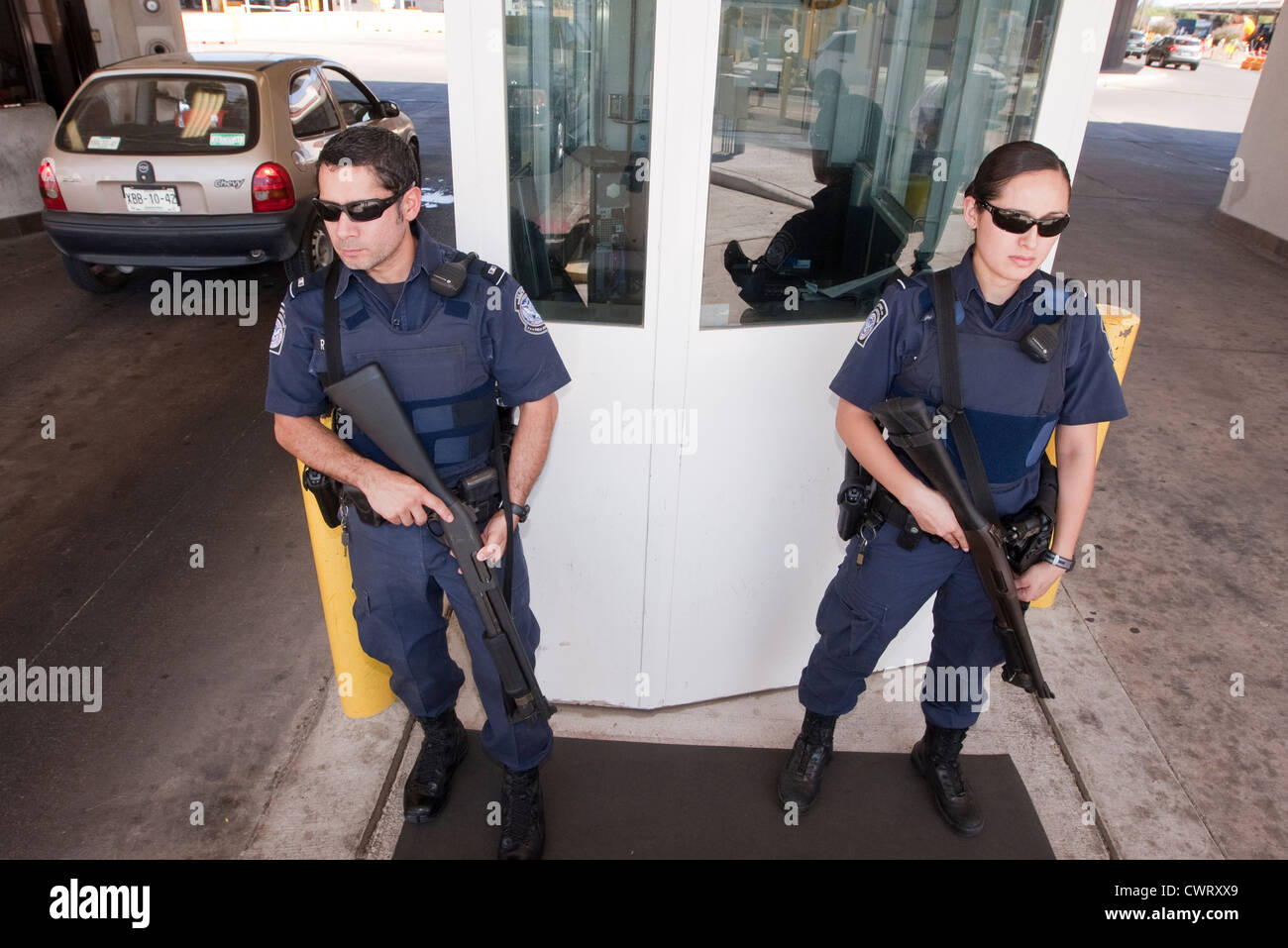 Male and female officers, stand guard with guns at the Laredo, Texas ...