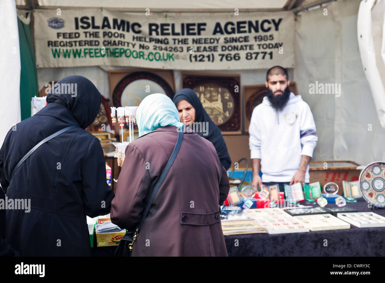 Stall holders and customers at a bazaar market stall raising money for ...