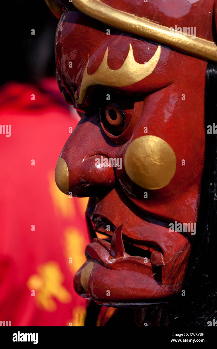A wooden mask of a god at the "Pigs of God" festival in Sanxia near ...
