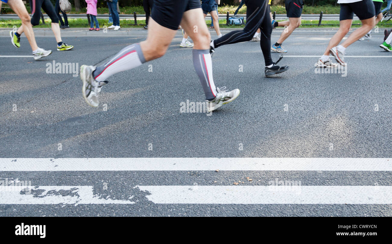 People running fast in a city marathon on street Stock Photo - Alamy