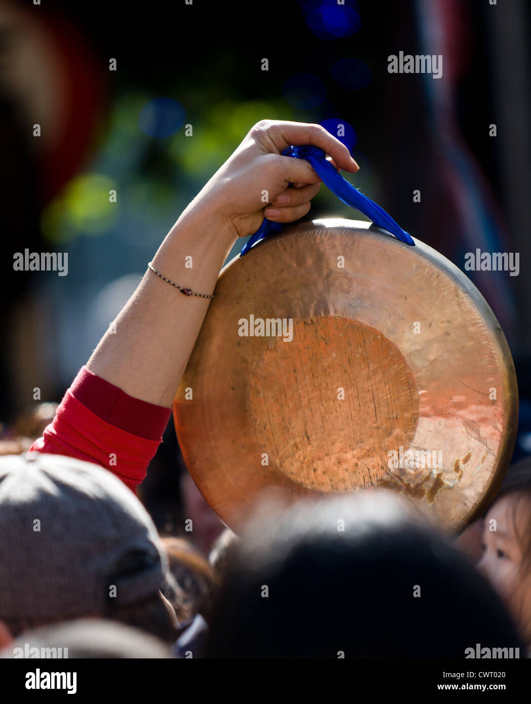 A gong is held above the crowd at the "Pigs of God" festival in Sanxia ...