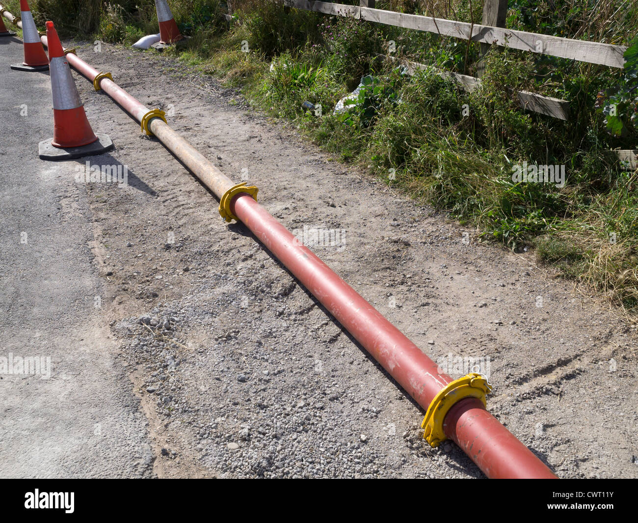 Temporary steel pipe with boltless joints laid on a road and used for ...