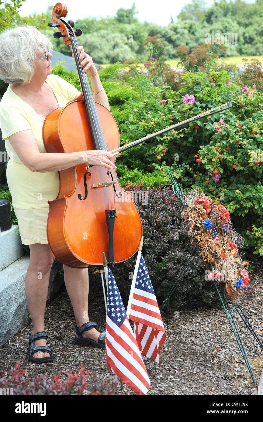 Female cellist performing Stock Photo - Alamy