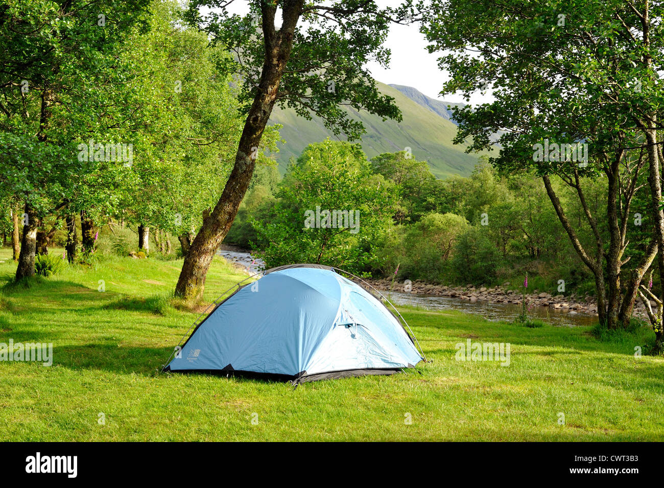 Camping by a river Stock Photo - Alamy