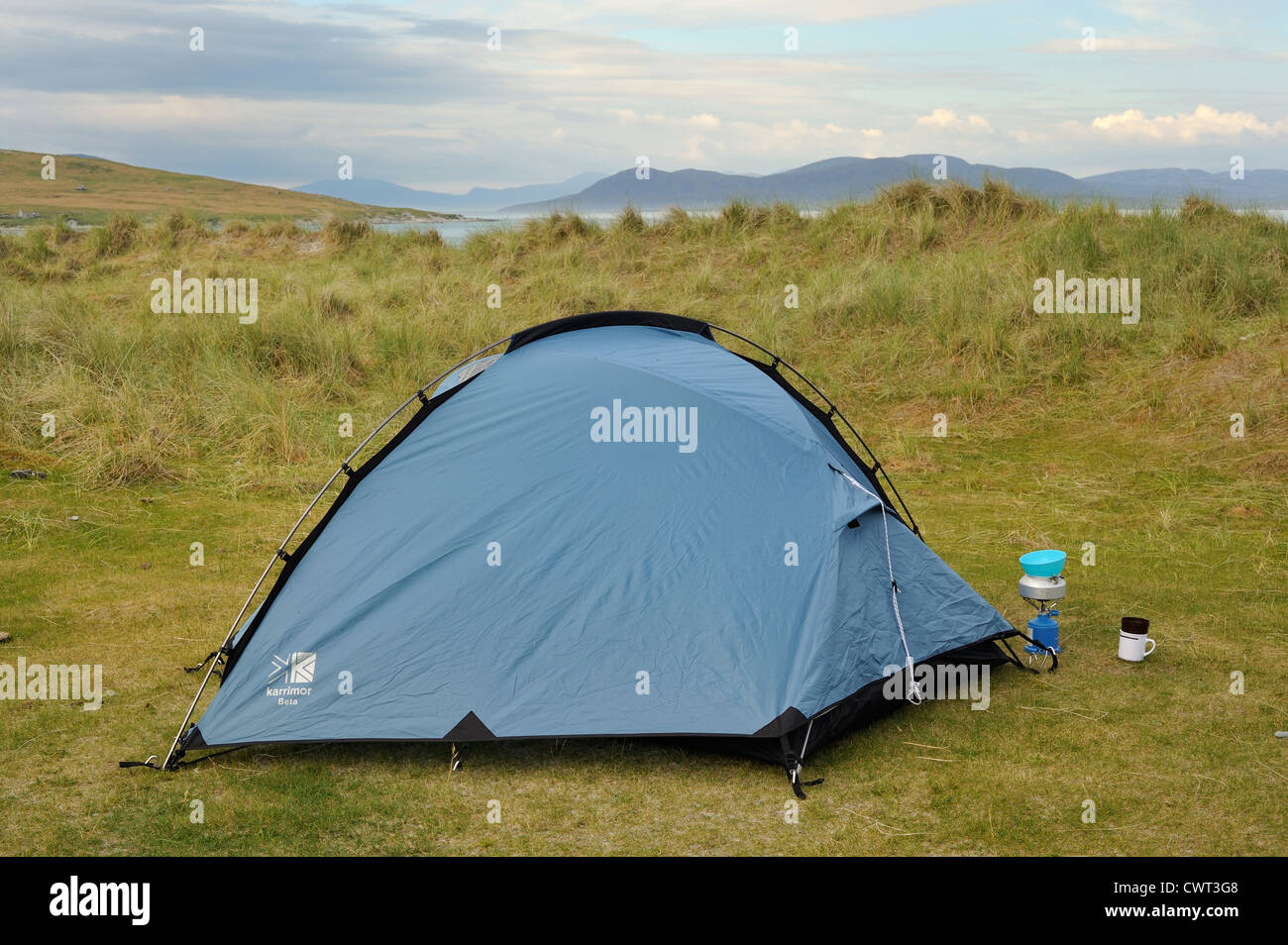 Wild camping on sand dunes by remote beach Stock Photo - Alamy