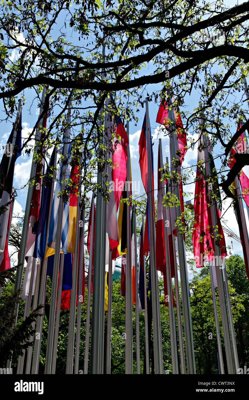 European Flags at the top of flag poles seen through trees, Munich ...
