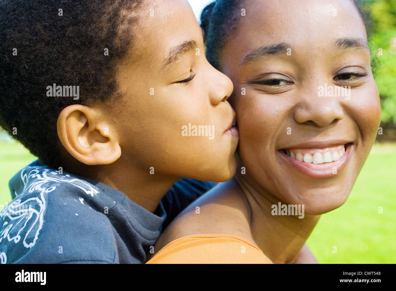 happy african boy kissing mother on her face Stock Photo - Alamy
