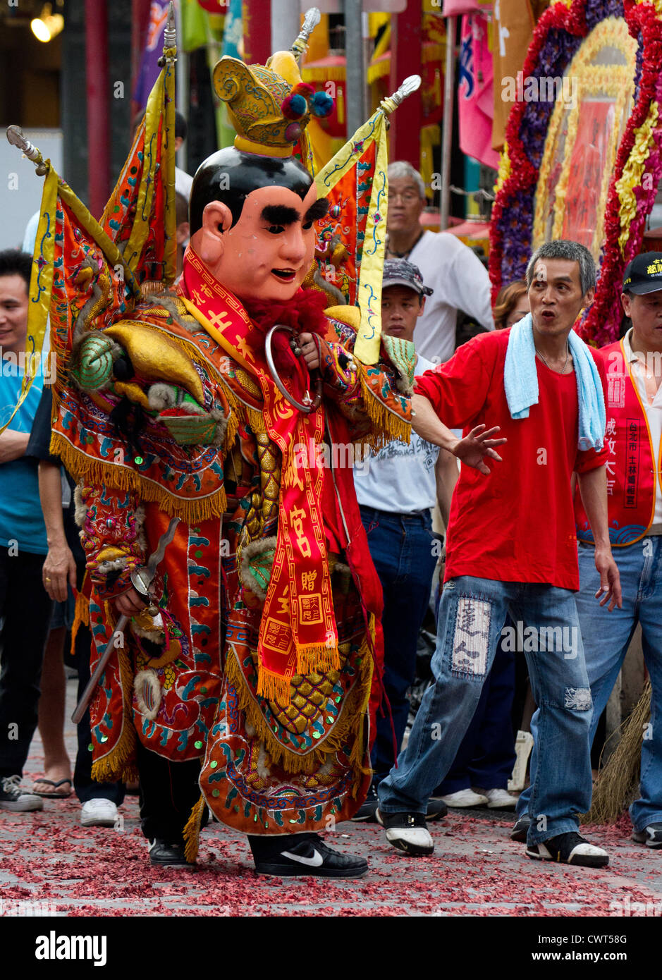 A figure of a taoist god parades through Shilin district in Taipei ...