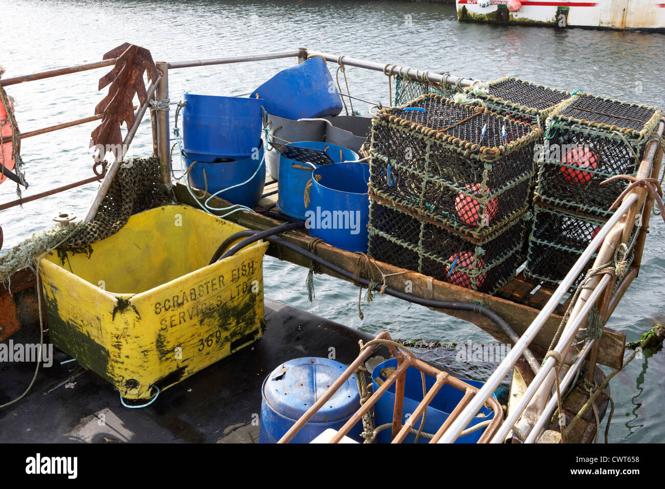 new lobster pots piled up in the back of a small fishing boat at John O ...