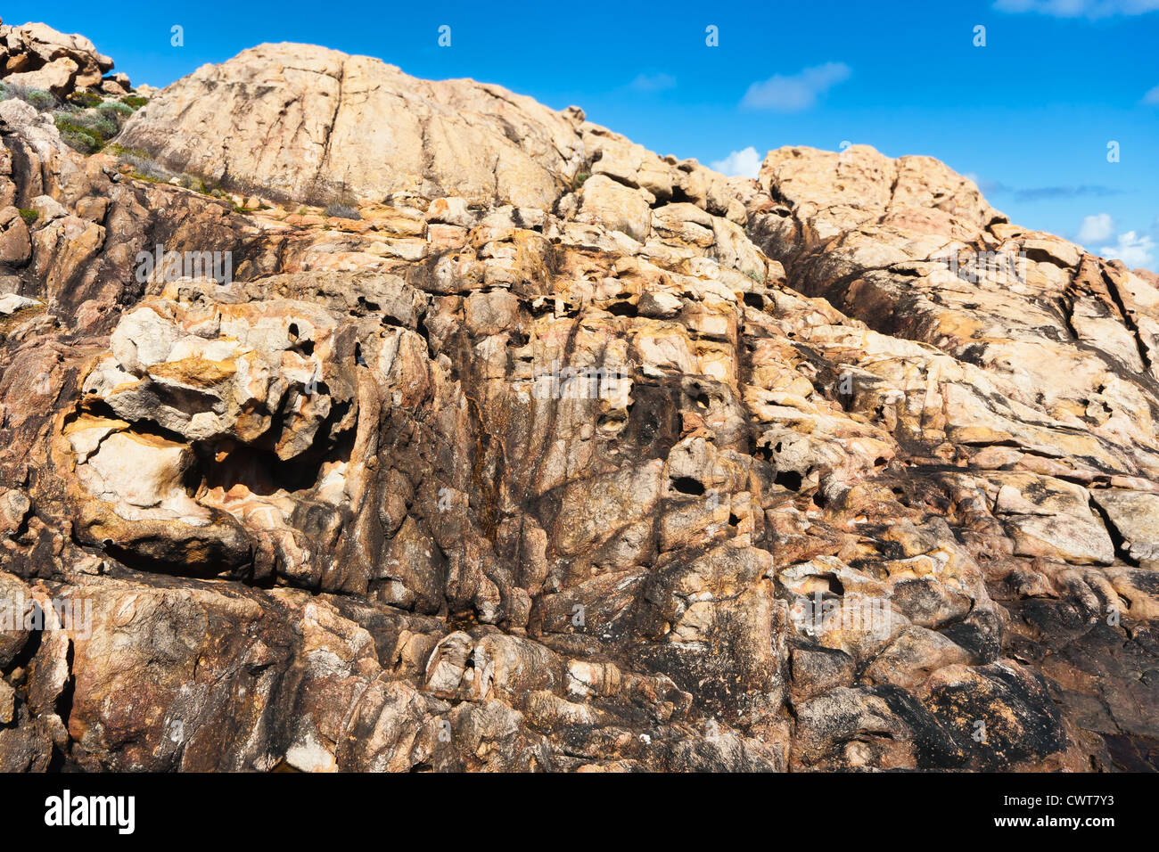 A series of rocks jut into the ocean creating a natural canal hollowed ...