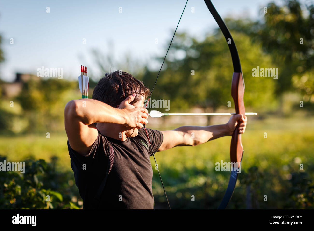 Young archer training with the bow Stock Photo - Alamy