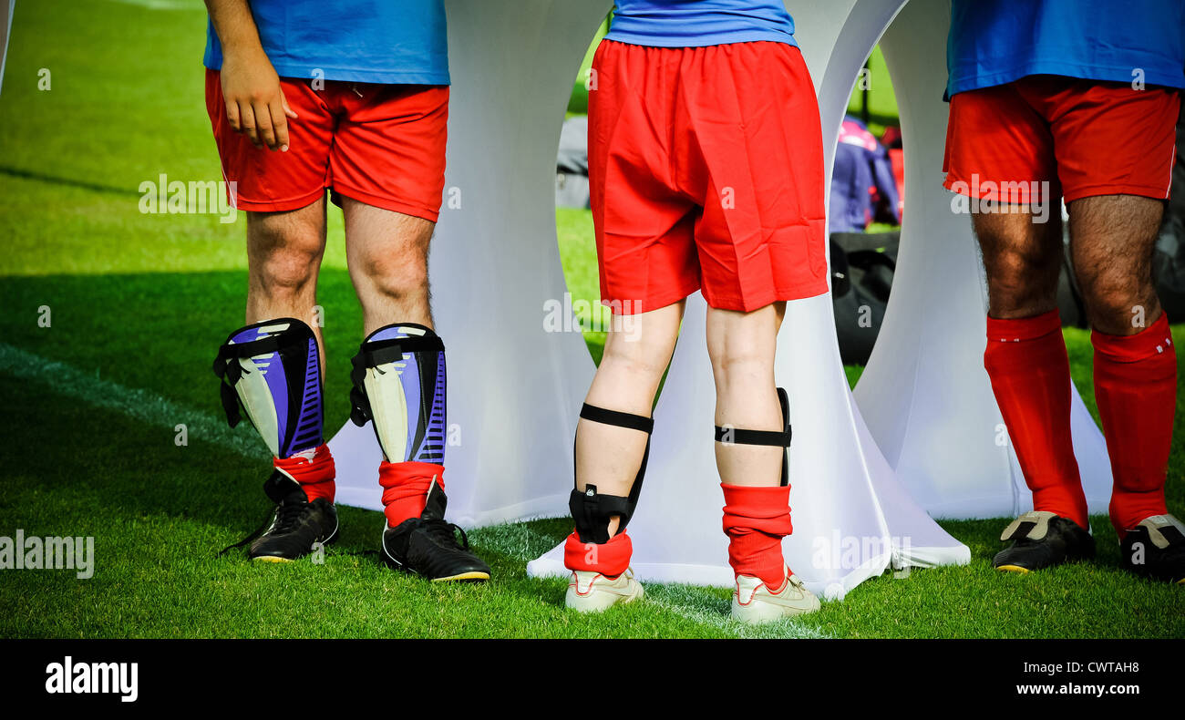 Three soccer players standing on soccer pitch Stock Photo - Alamy