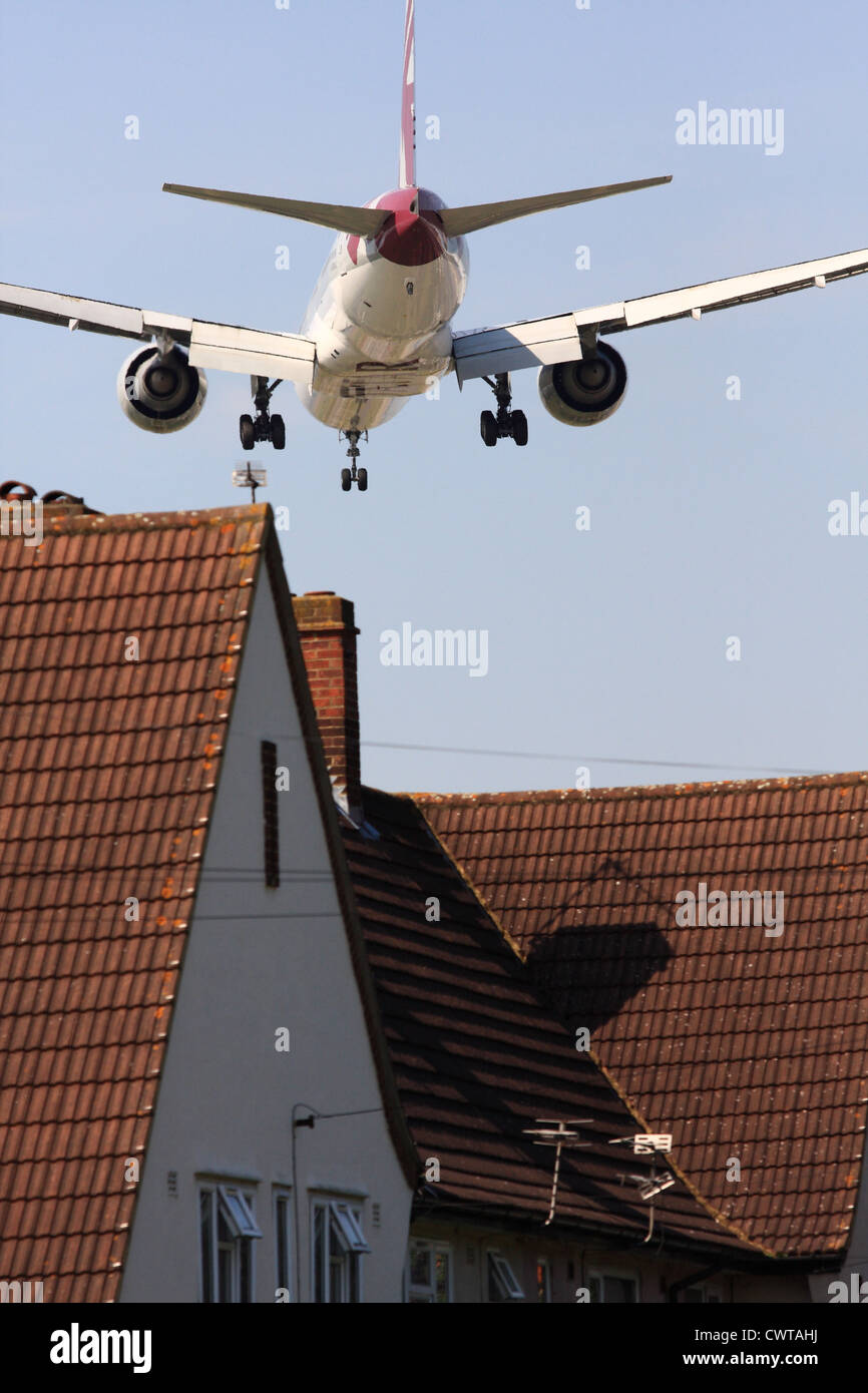 An aircraft flying over houses as it comes in to land at Heathrow ...