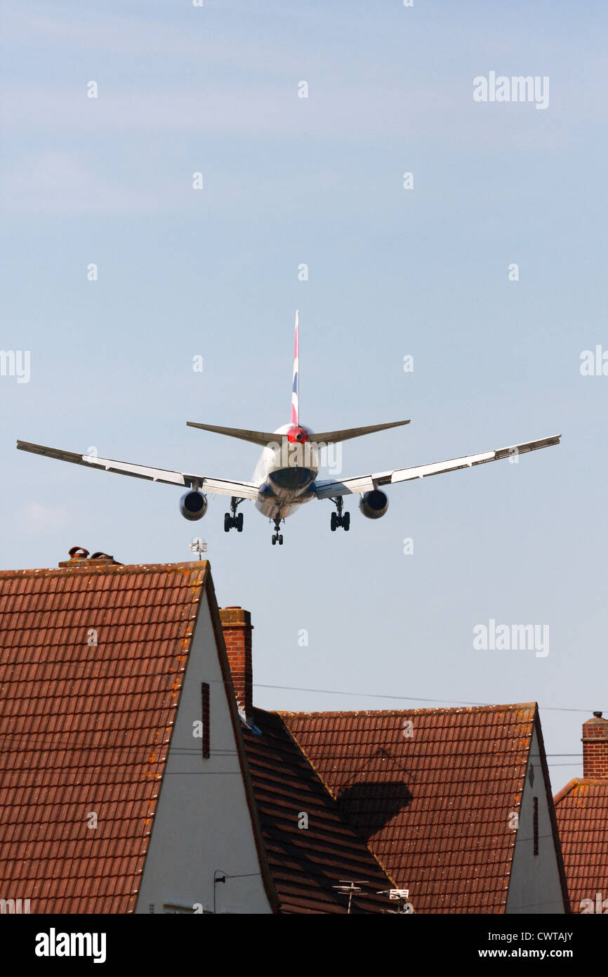 An aircraft flying over houses as it comes in to land at Heathrow ...