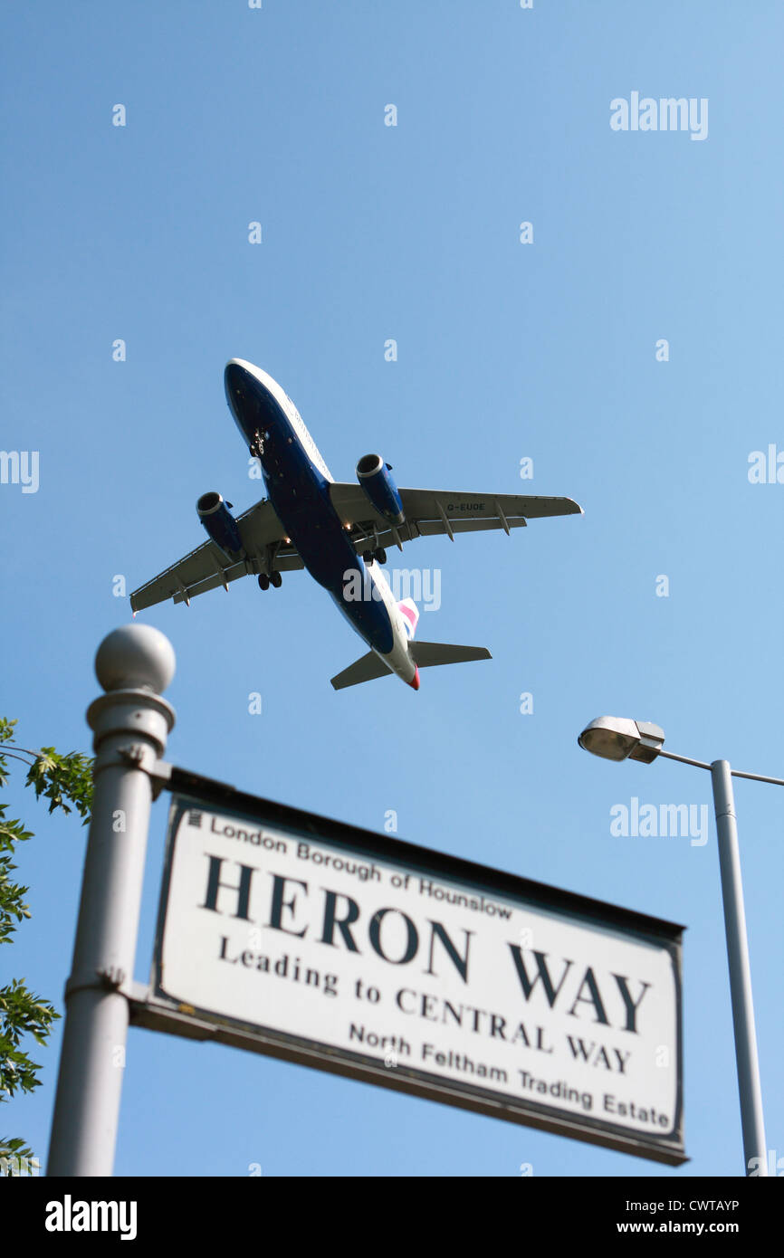 an aircraft flying over a road sign in The London Borough of Hounslow ...