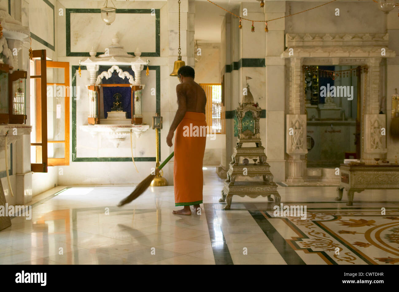 PRIEST CLEANING THE JAIN TEMPLE FLOOR IN COCHIN INDIA Stock Photo - Alamy