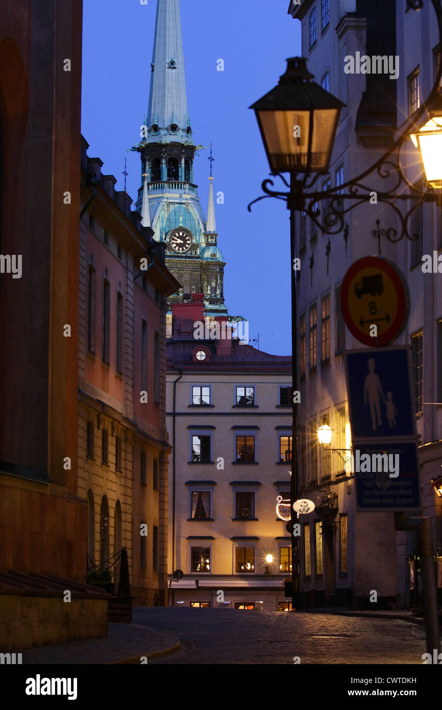 Gamla Stan at dusk, with the tower of Tyska Kyrkan visible in the ...