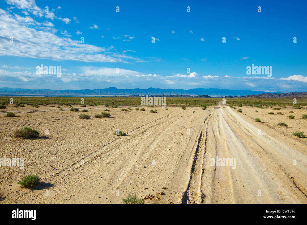 Dry road through steppe in far mountains in bright day Stock Photo - Alamy