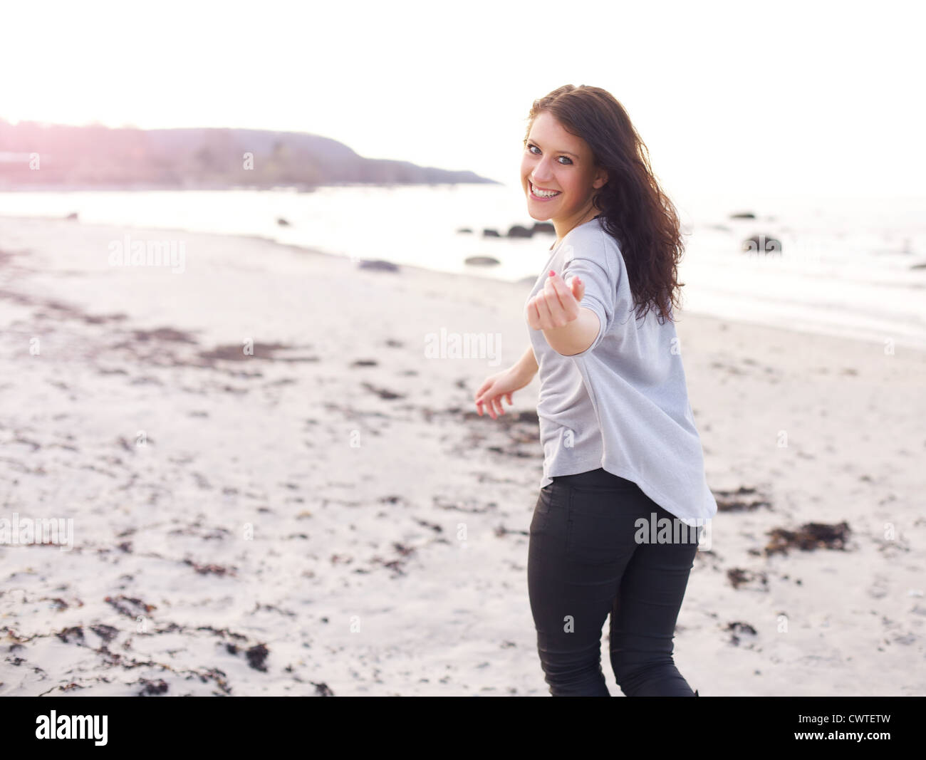 Young woman having fun and inviting you to join her Stock Photo - Alamy