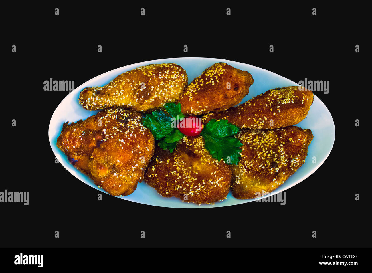 plate full of crispy chicken isolated on black Stock Photo - Alamy