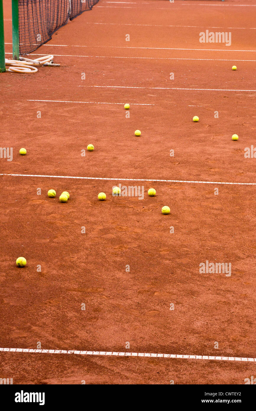 tennis balls scattered on a court Stock Photo - Alamy