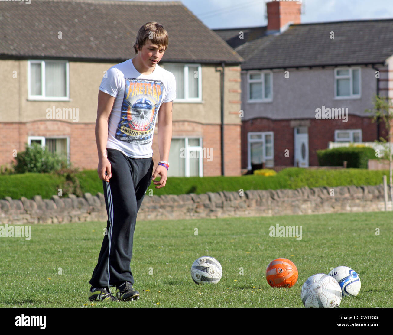 teenager playing football Stock Photo - Alamy