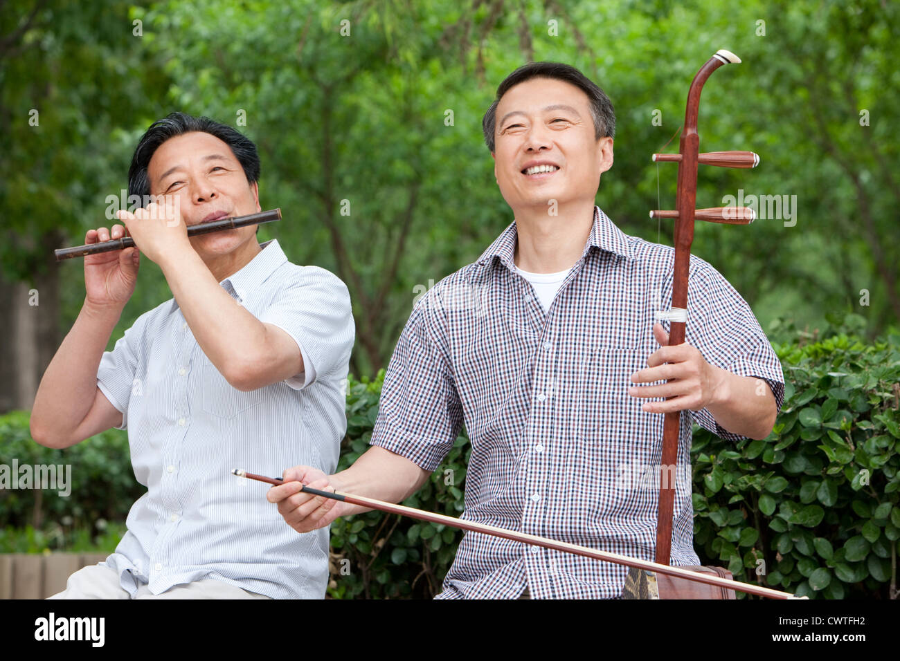 Old men playing Chinese traditional instrument in park Stock Photo - Alamy