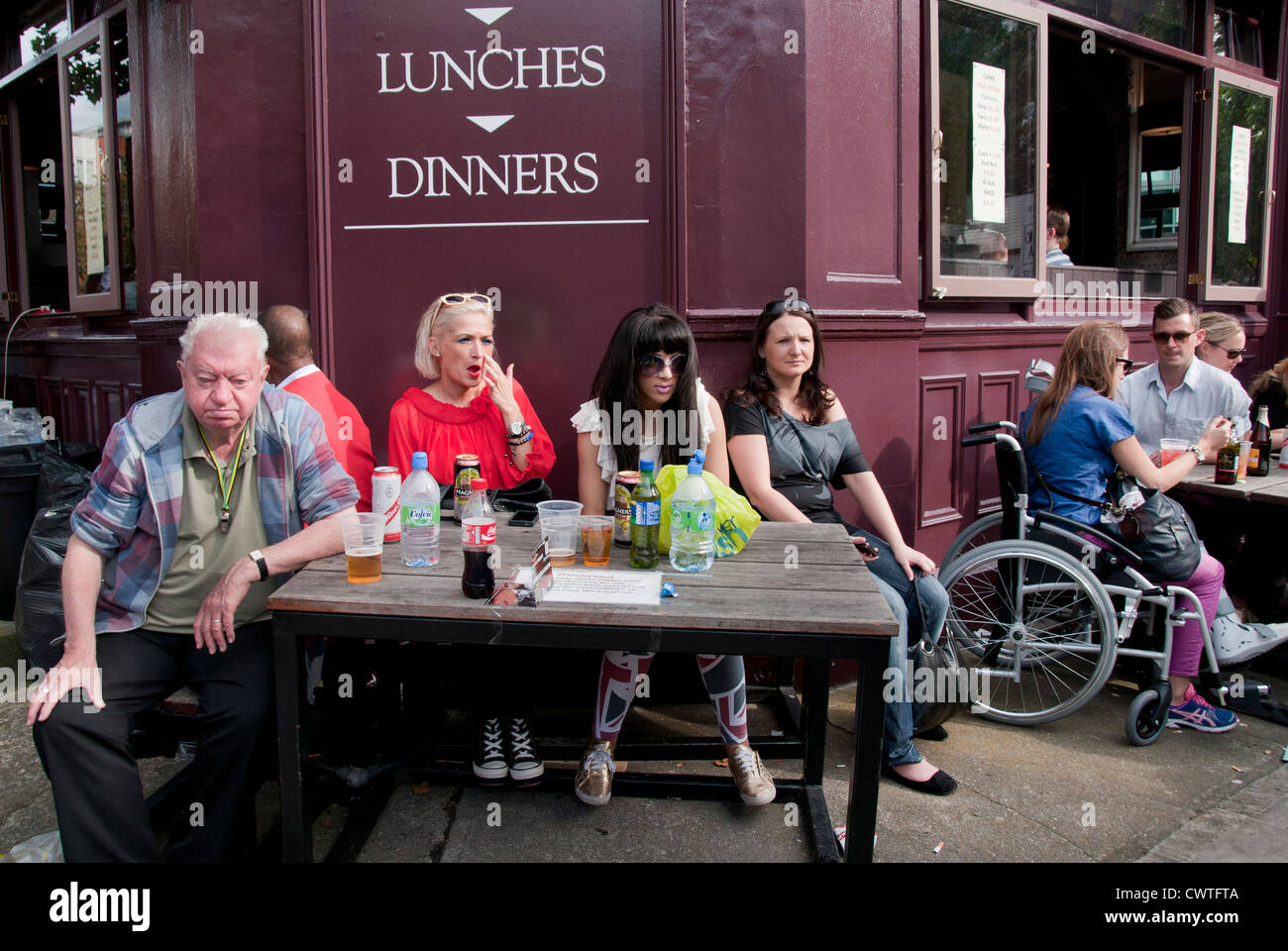 People sitting together outside pub drinking but not talking Stock ...