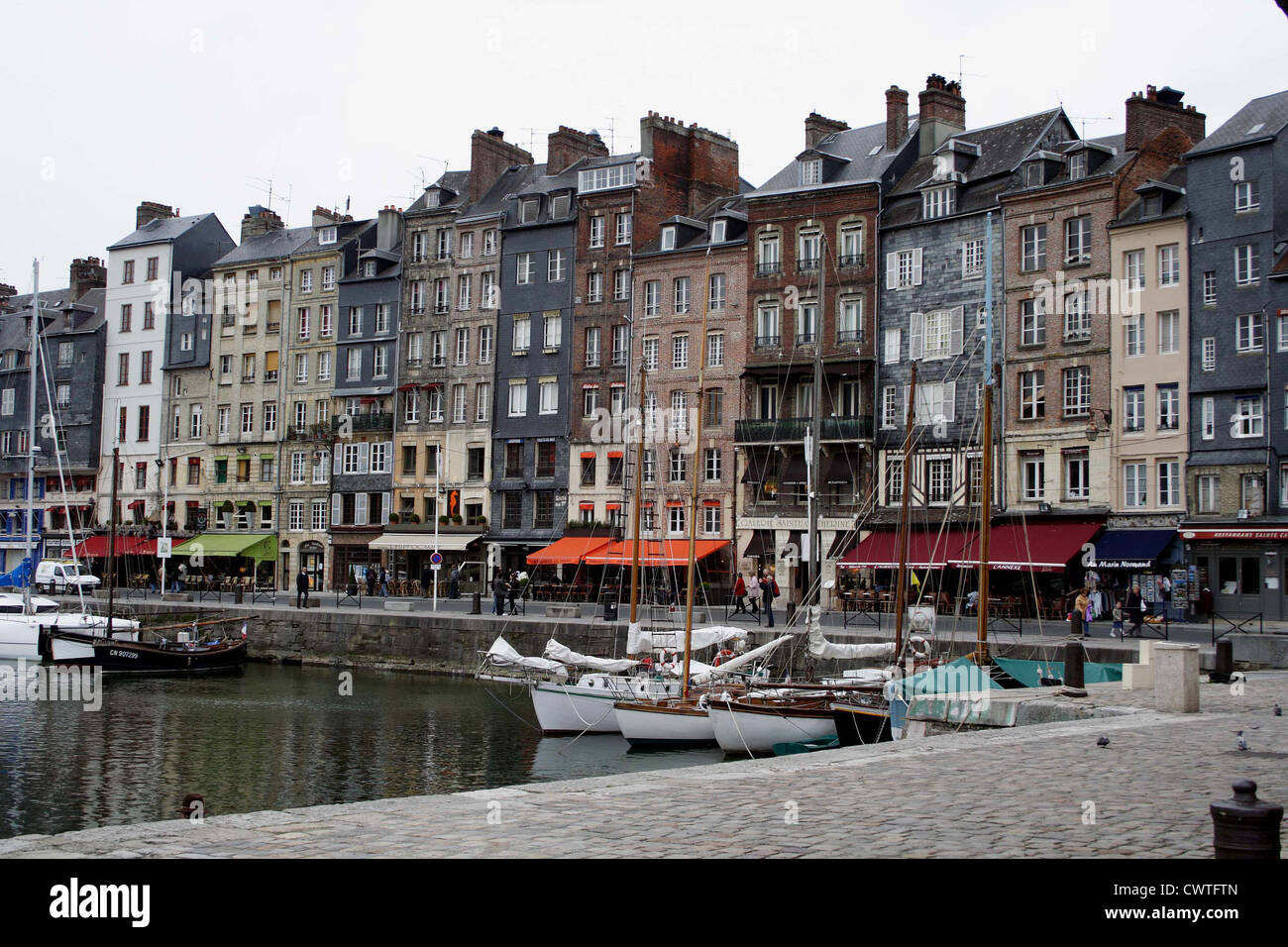 The marina at Honfleur, showing shops, café's and restaurants, with ...