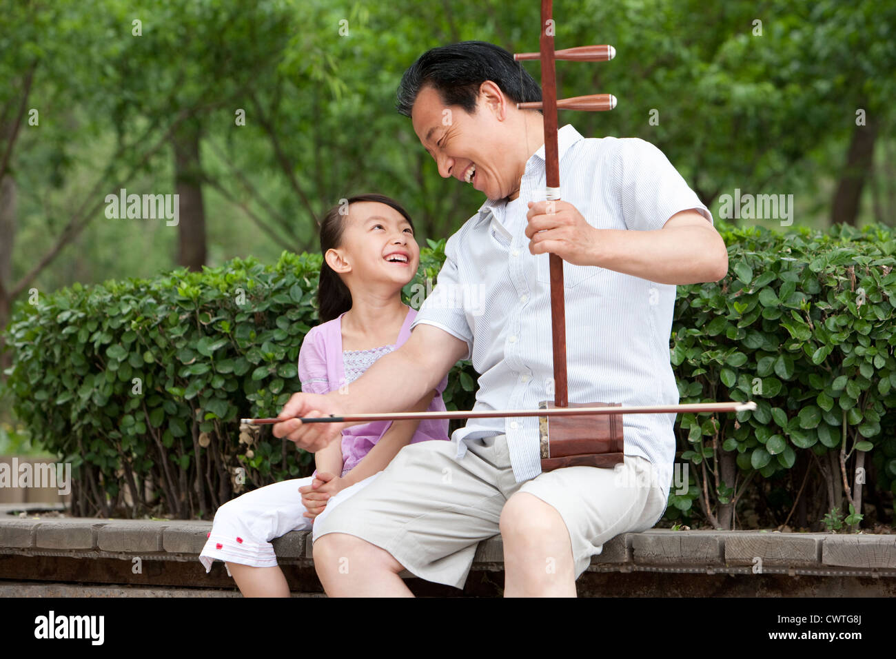 Grandfather playing Chinese traditional musical instrument Erhu Stock ...