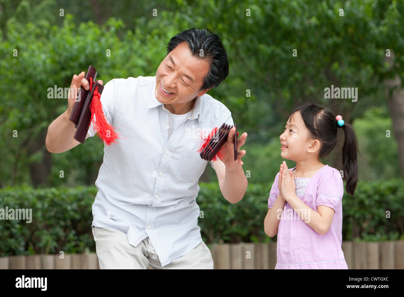 Grandfather playing Chinese traditional musical instrument Kuaiban ...