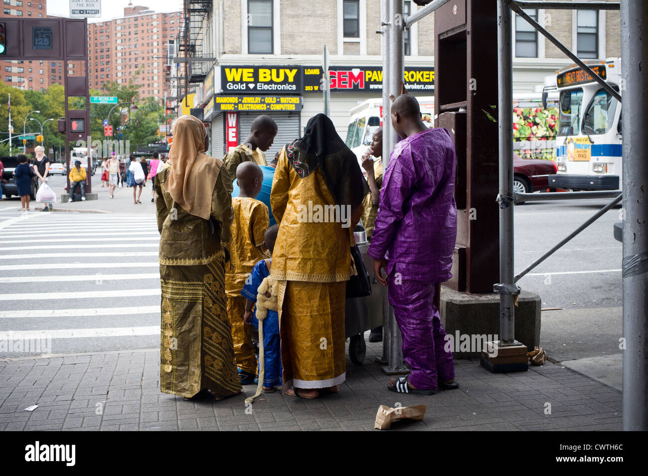 A Muslim family seen on a street corner in the neighborhood of Harlem ...