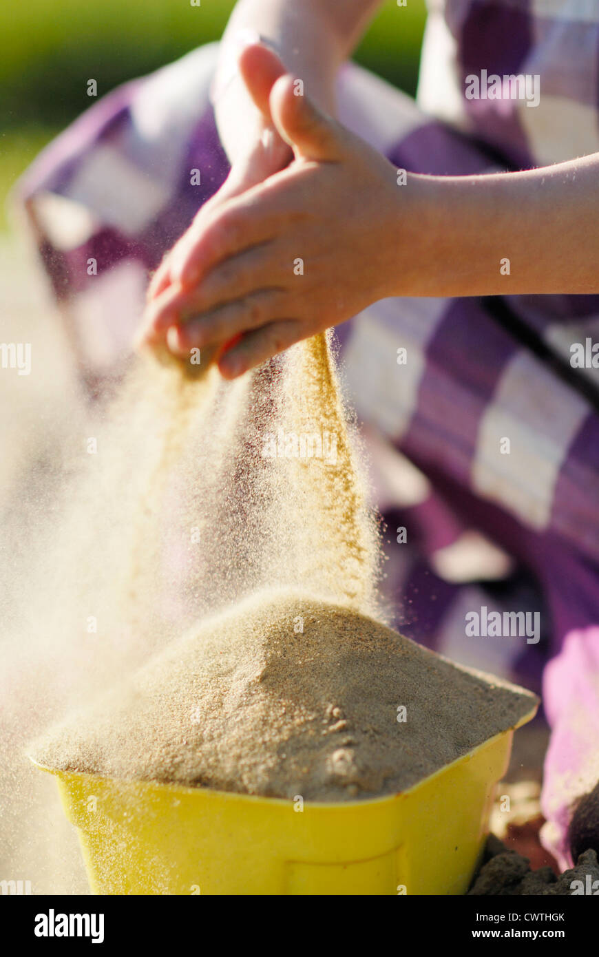 Little kid playing with sand Stock Photo - Alamy