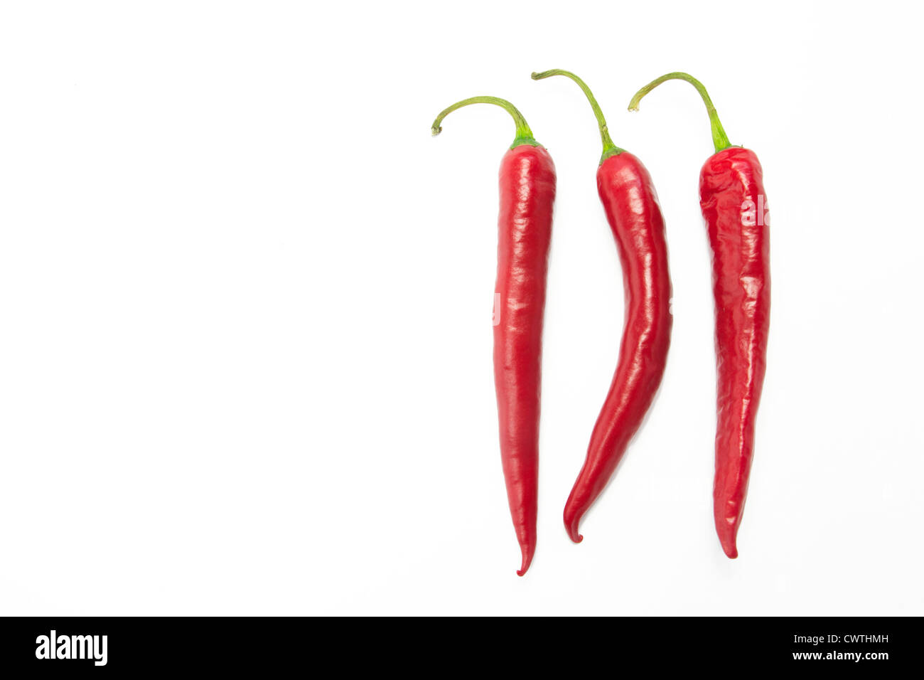 3 Red Chillies in a row Stock Photo - Alamy