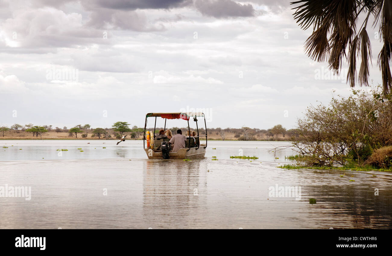 Tourists on a boat safari, Lake Manze, Selous Game Reserve Tanzania ...