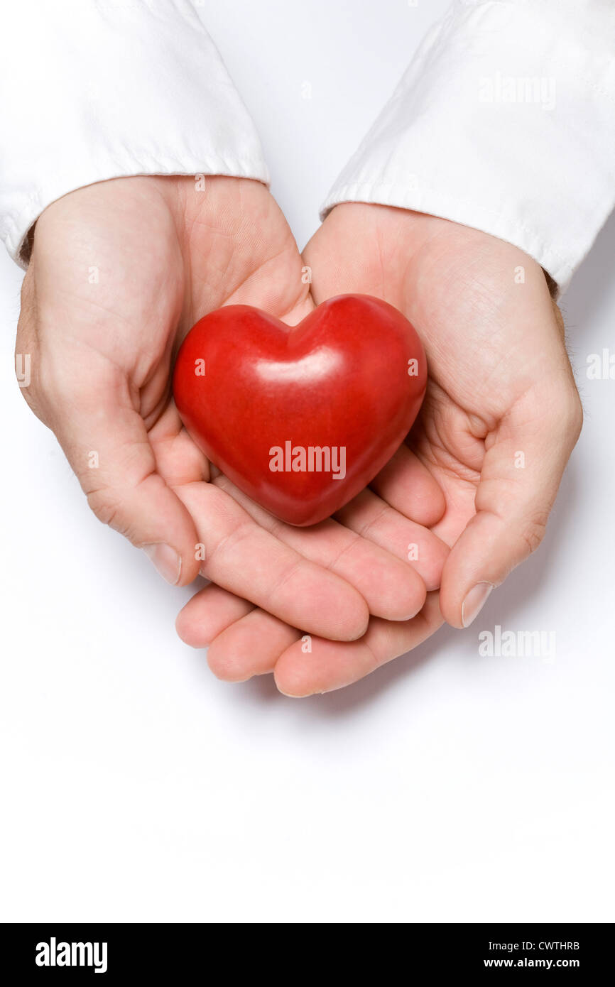 Red heart in hands Stock Photo - Alamy